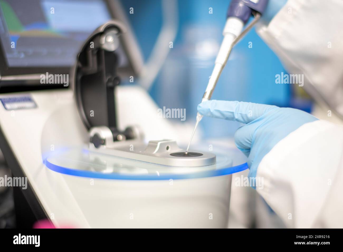 Scientist using pipette and spectrophotmeter in biotech lab Stock Photo ...