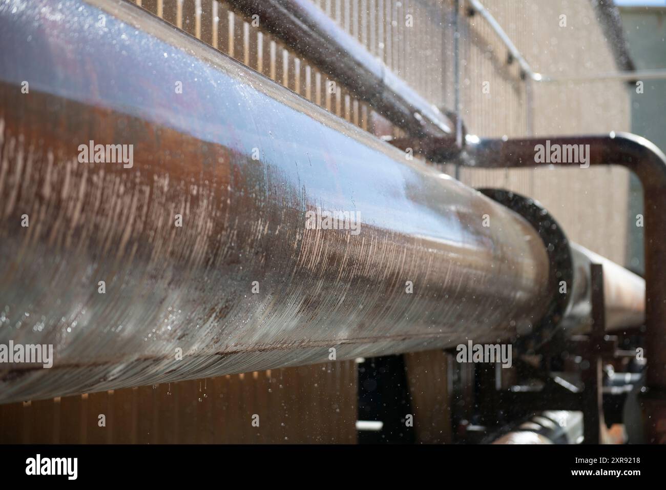 Large industrial horizontal water pipe with water spraying aroun Stock ...