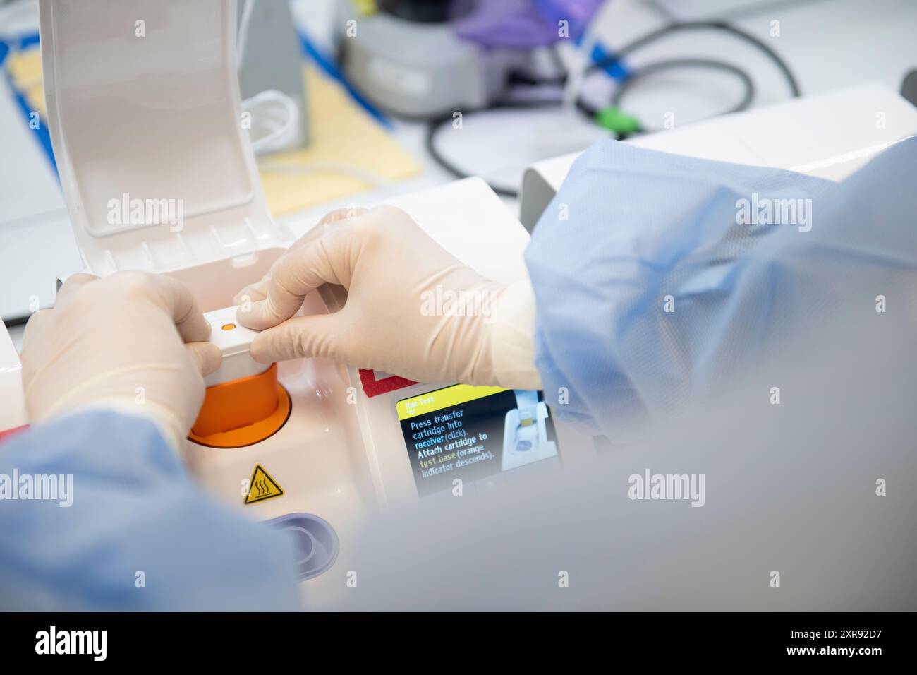 Lab technician placing cartridge into point-of-care testing mach Stock ...