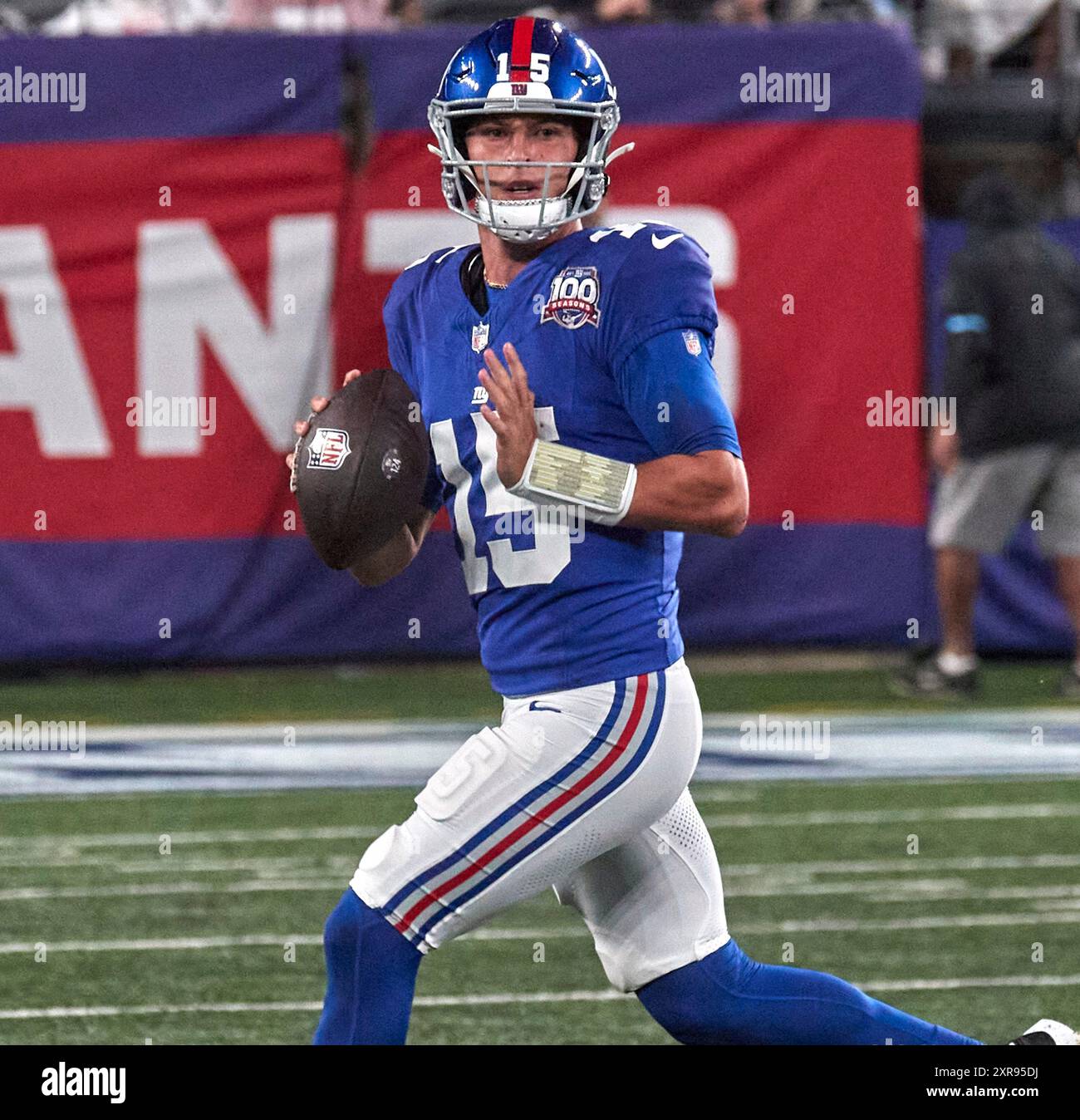 New York Giants quarterback Tommy DeVito (15) rolls out to pass against ...