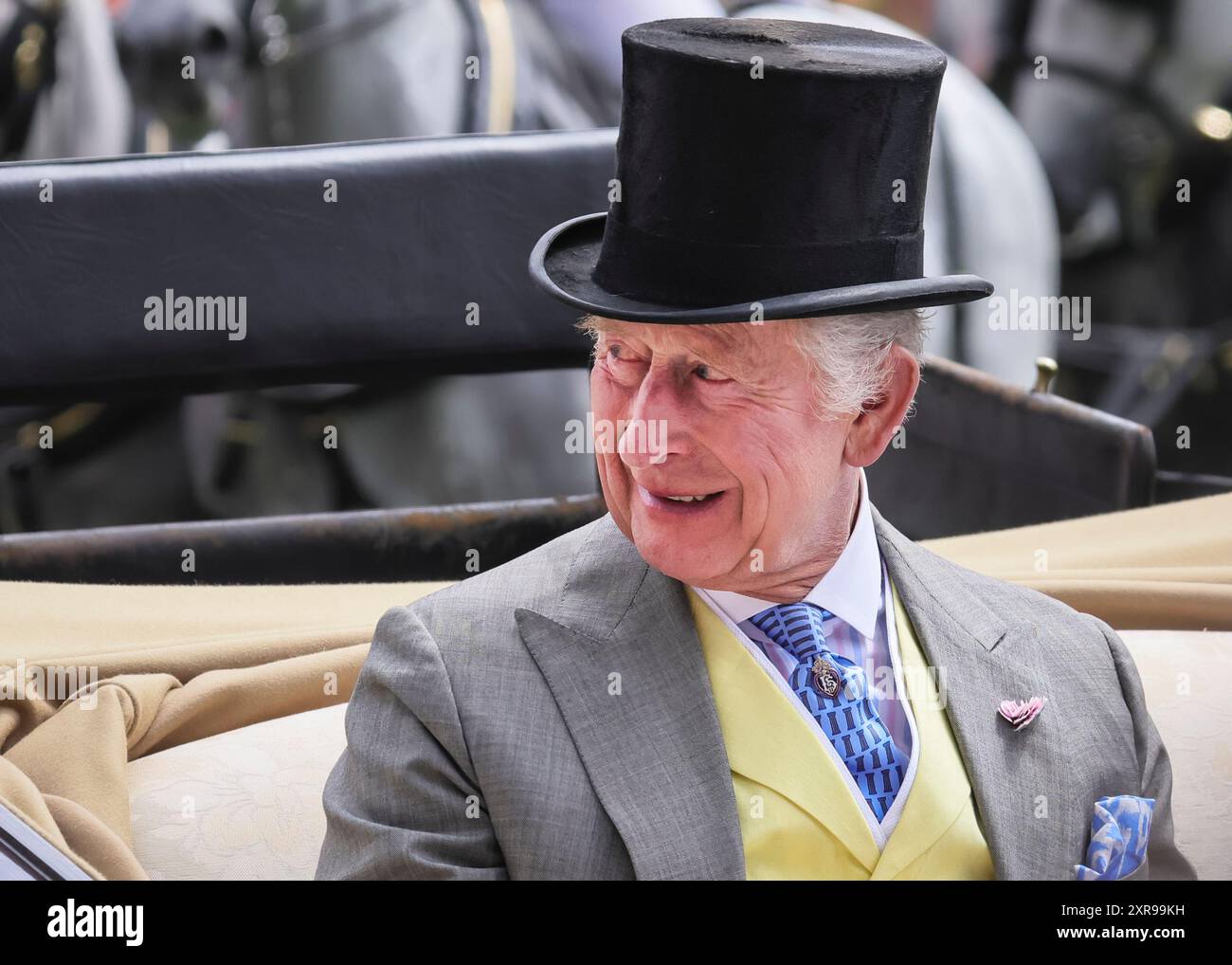 King Charles III smiling, in top hat in the Royal Procession carriage ...