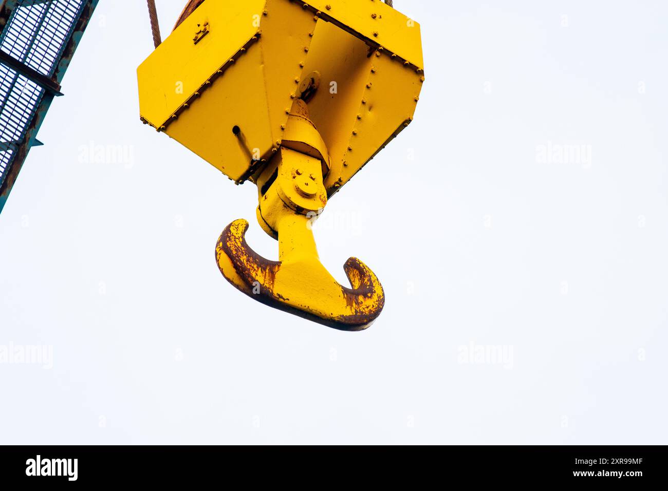 Yellow massive hook and block of a wharf crane Stock Photo - Alamy
