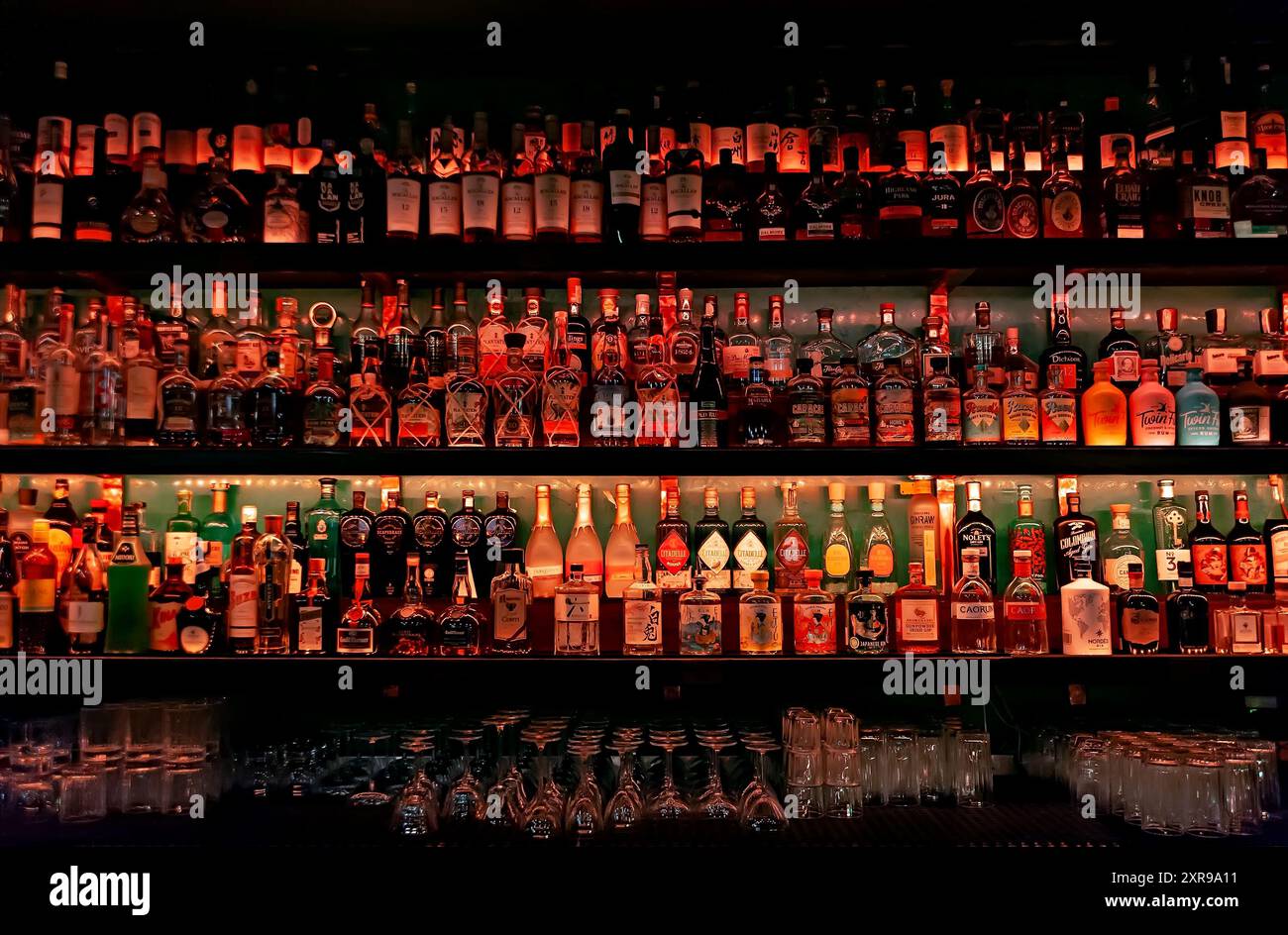 Bottles of alcohol and spirits on backlight shelves at Elixir Cocktail ...