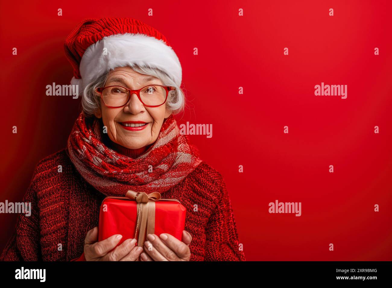 Christmas banner grandmother in a santa hat holding a gift on a red ...