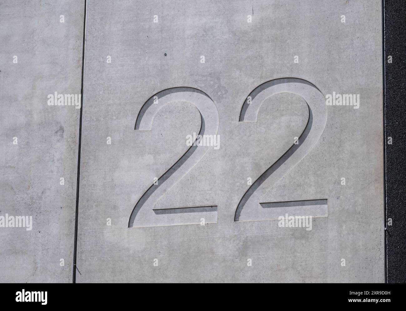 The number 22 embedded into a concrete facade Stock Photo - Alamy