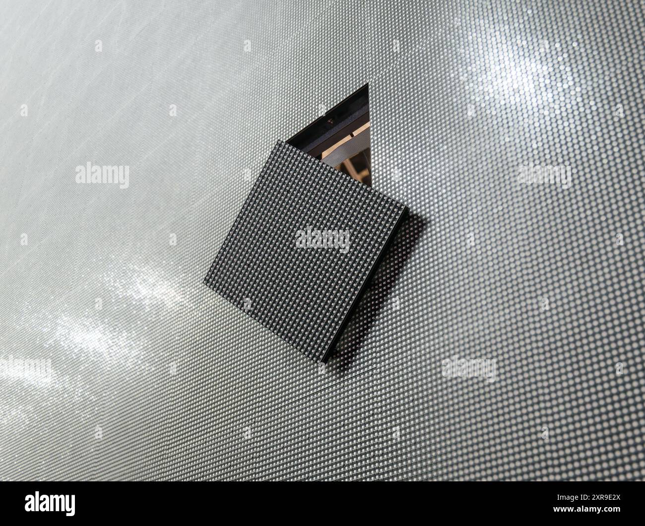 A square LED module fallen out of its place on the surface of a large ...
