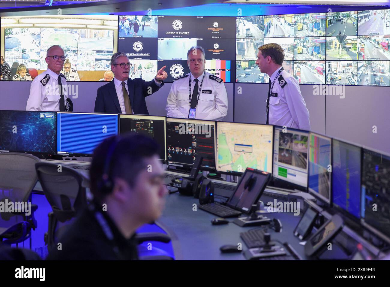 Prime Minister Keir Starmer gestures while he views CCTV screens with ...