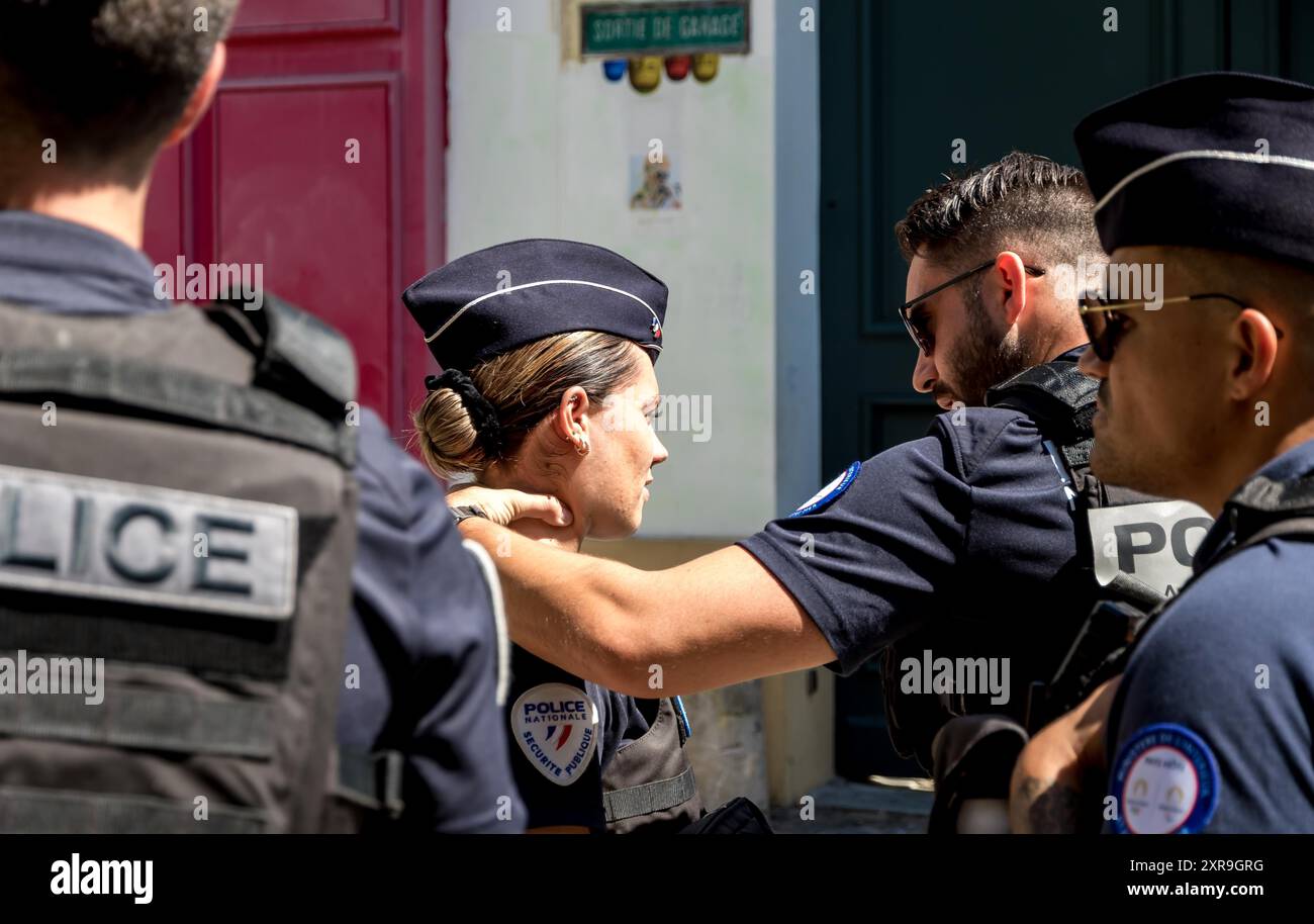 8th August 2024. Police officer holding neck of colleague near ...