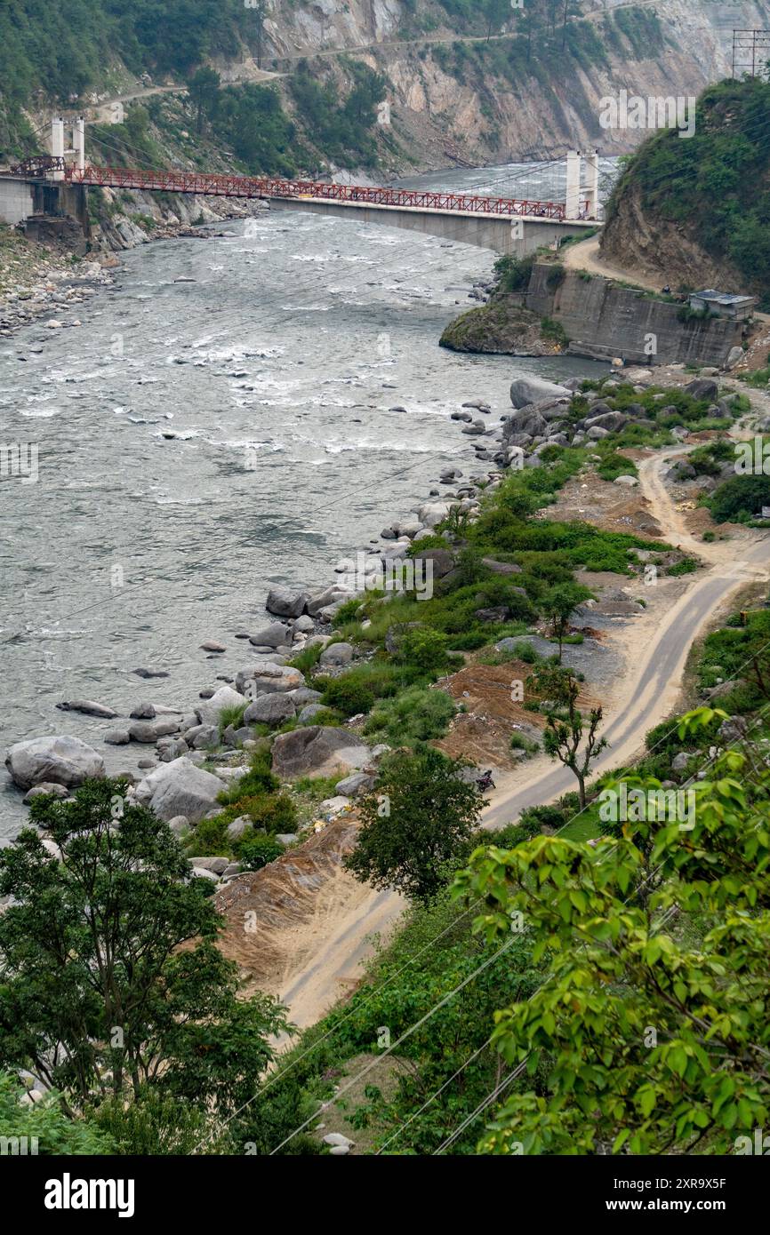 A long bridge spanning between two hills with the Ravi River flowing underneath in the Chamba ...