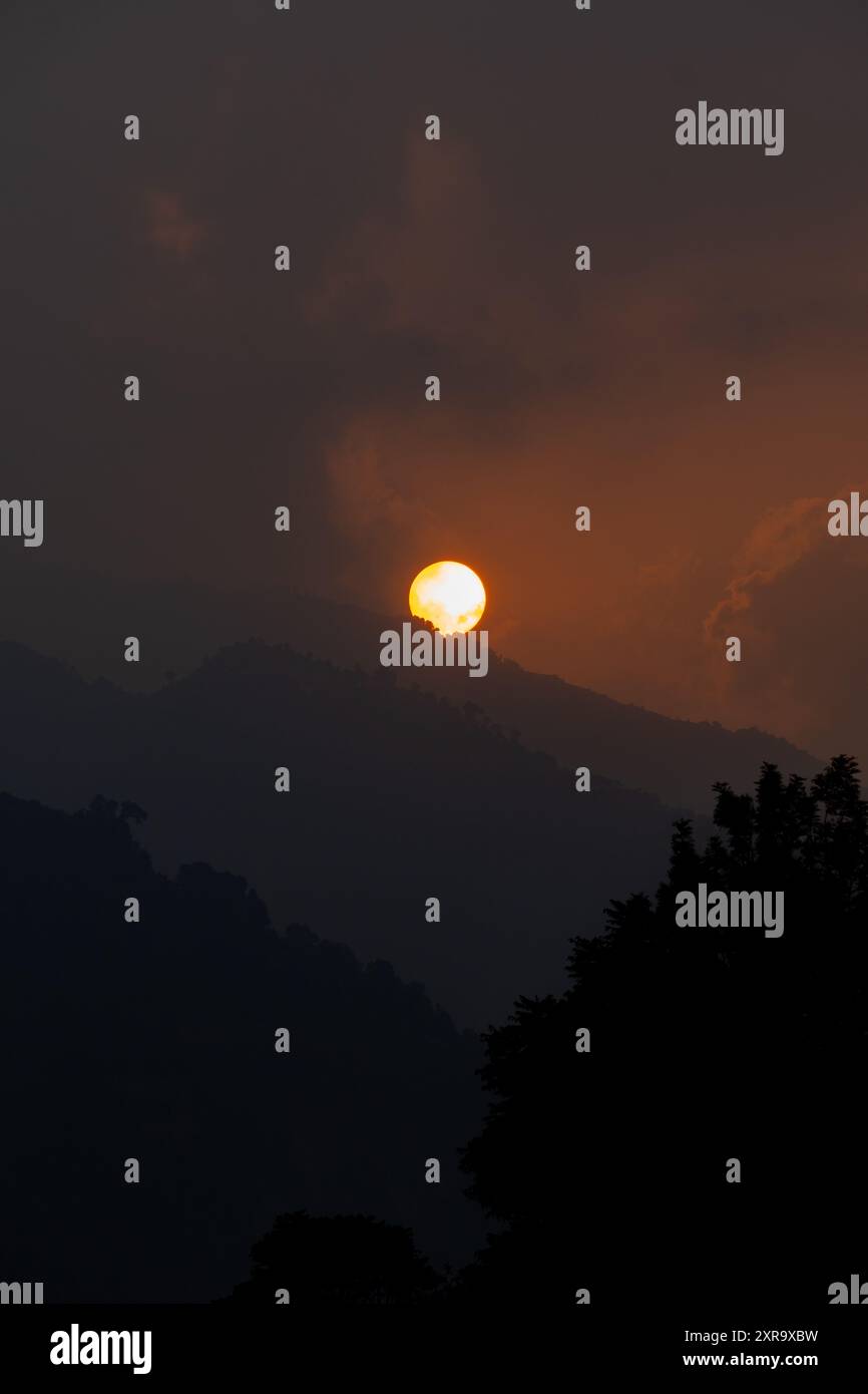 A stunning dawn featuring an orange sun and sky setting over the ...