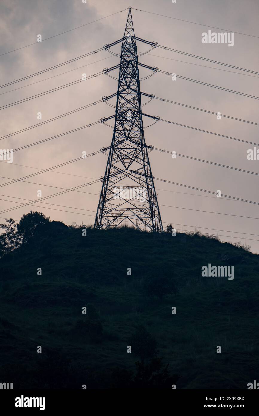 A transmission power tower with high tension wires situated on a ...