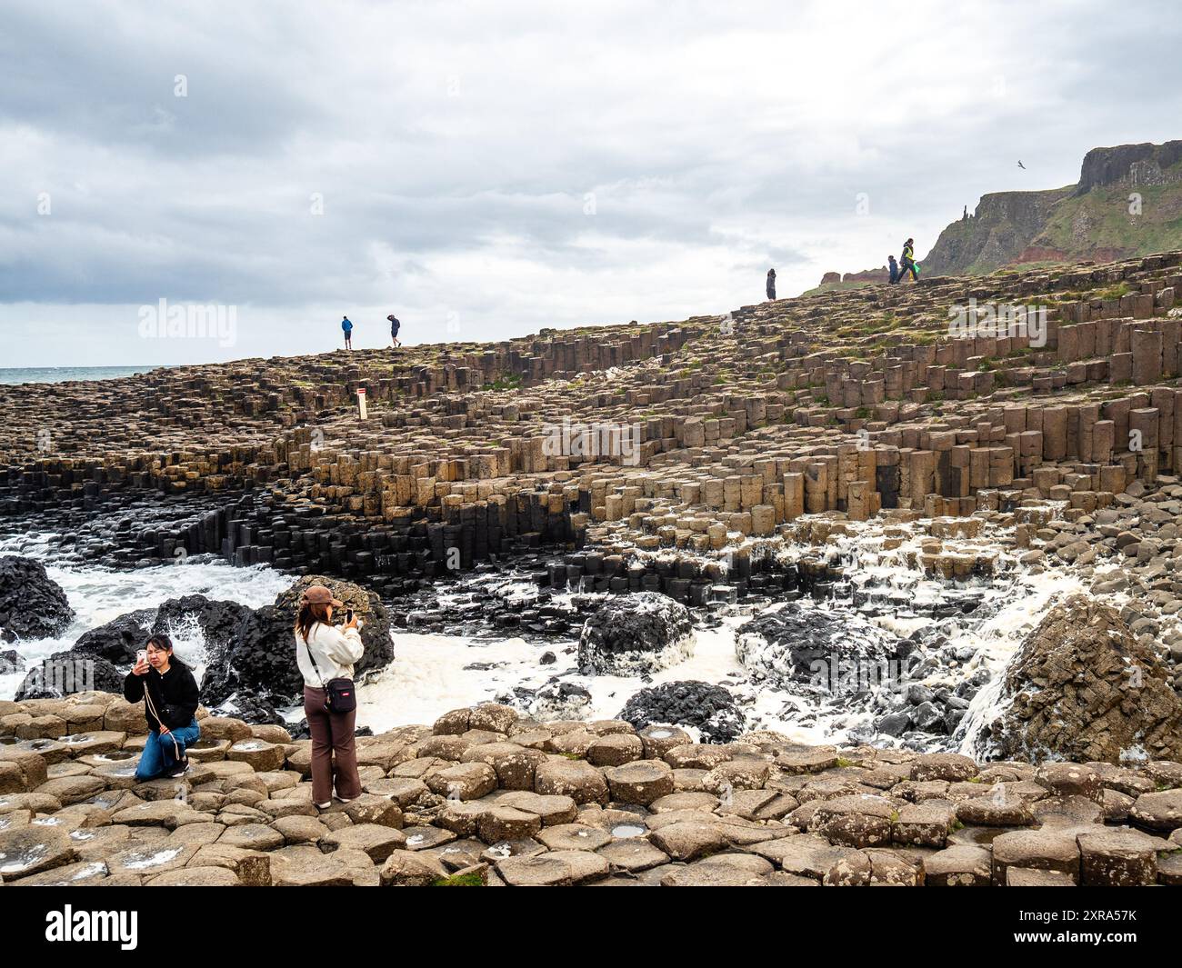 People taking photos of the stones. The Giant’s Causeway and Causeway ...