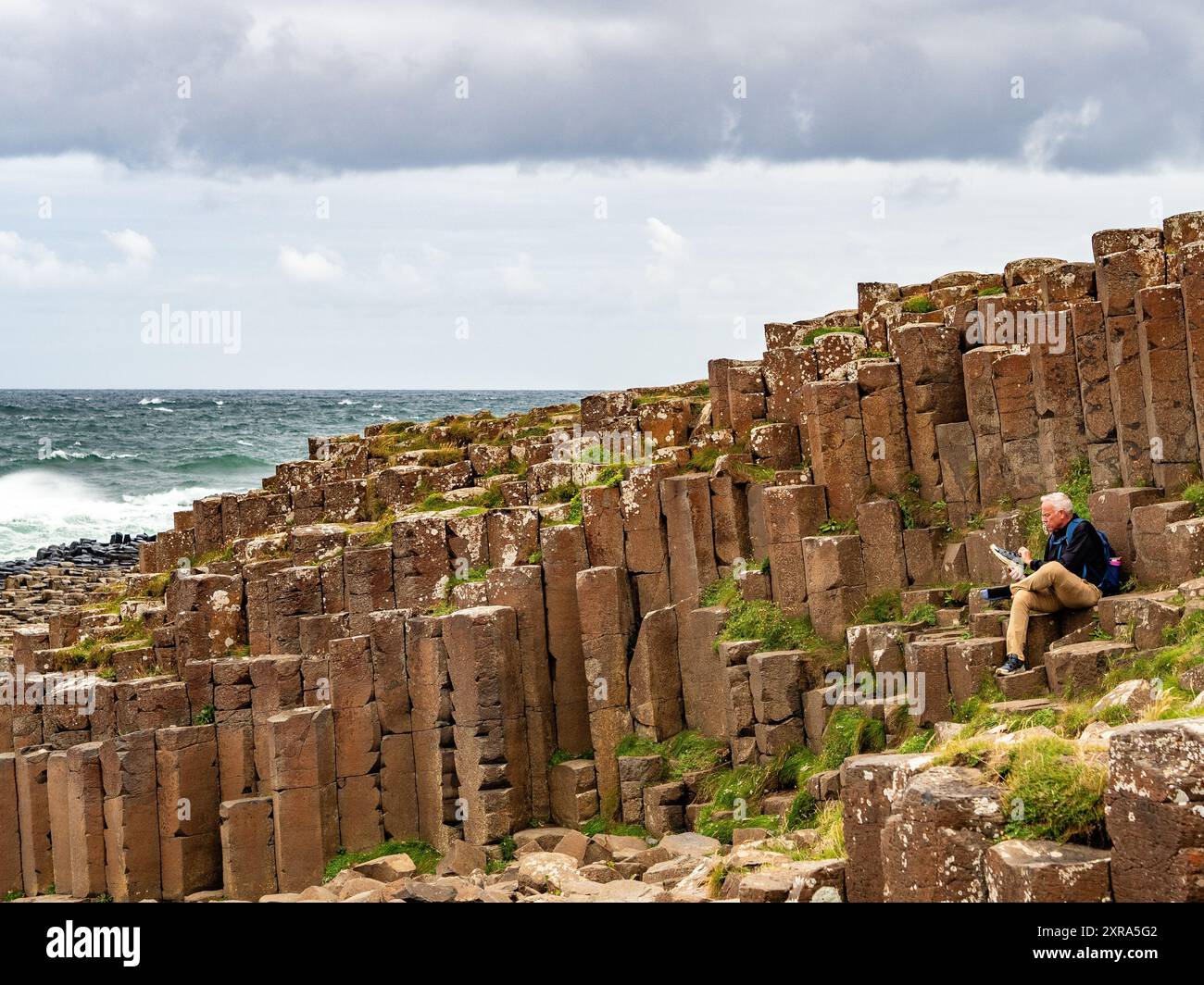 A man relaxing at the hexagonal-shaped stepping stones. The Giant’s ...