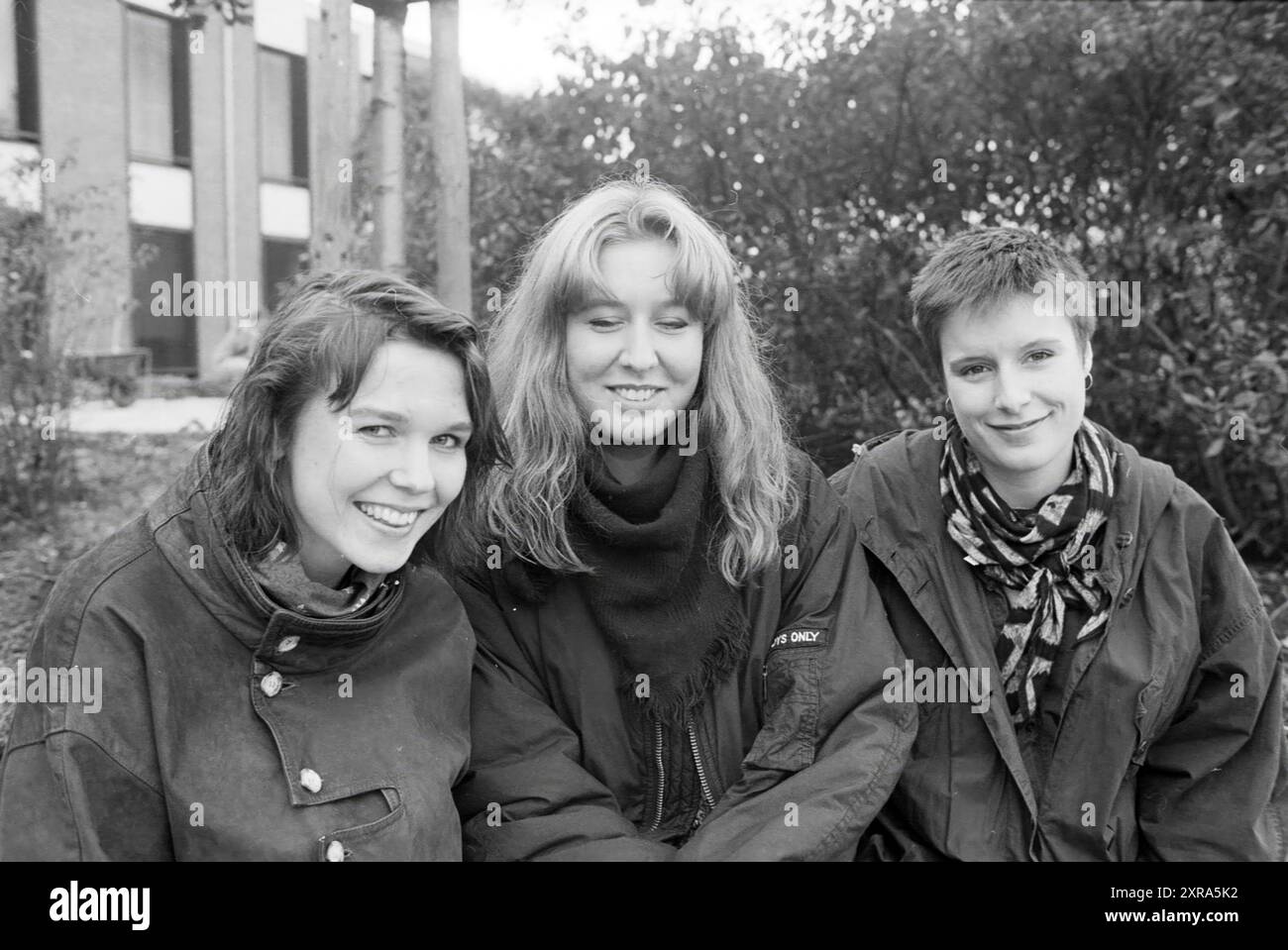 Three Swedish girls at H.D., posing in front of a company building ...