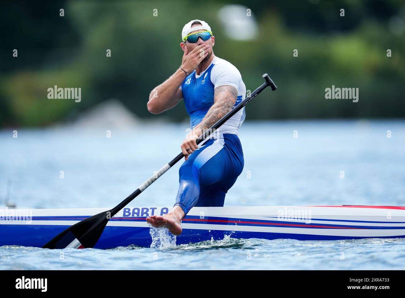 Adrien Bart, of France, gestures in the finish area after competing the men's canoe single 1000 ...