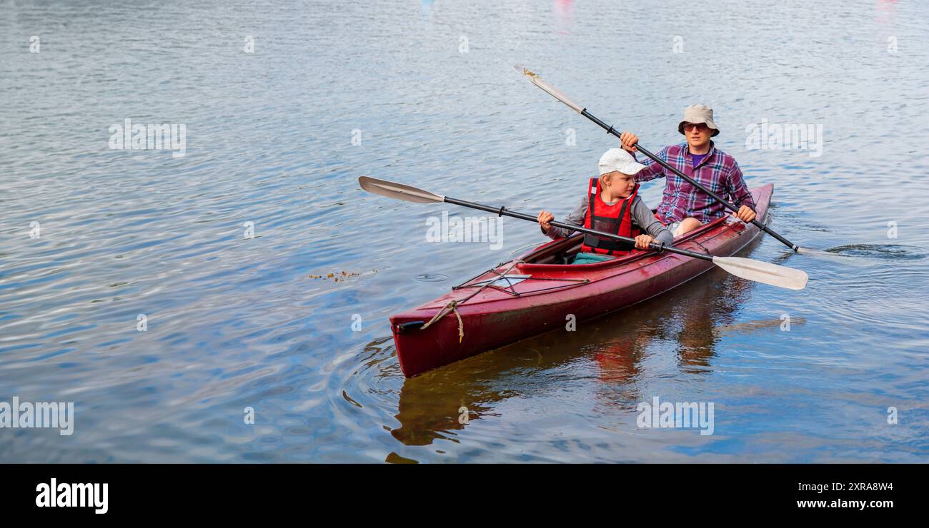 Father and son together, family activity by kayaking at the sea ...