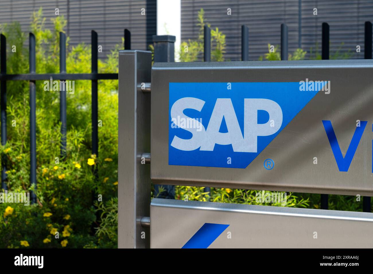 SAP SE logo prominently displayed on modern corporate headquarters facade, SAP corporate campus ...