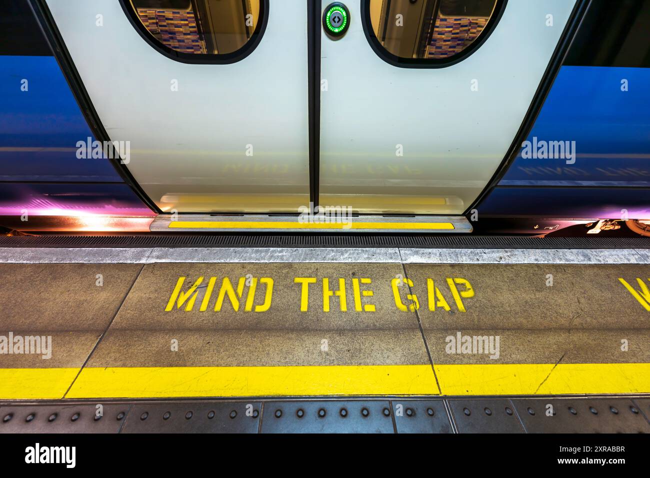 London underground tube train station platform with Mind the Gap sign ...