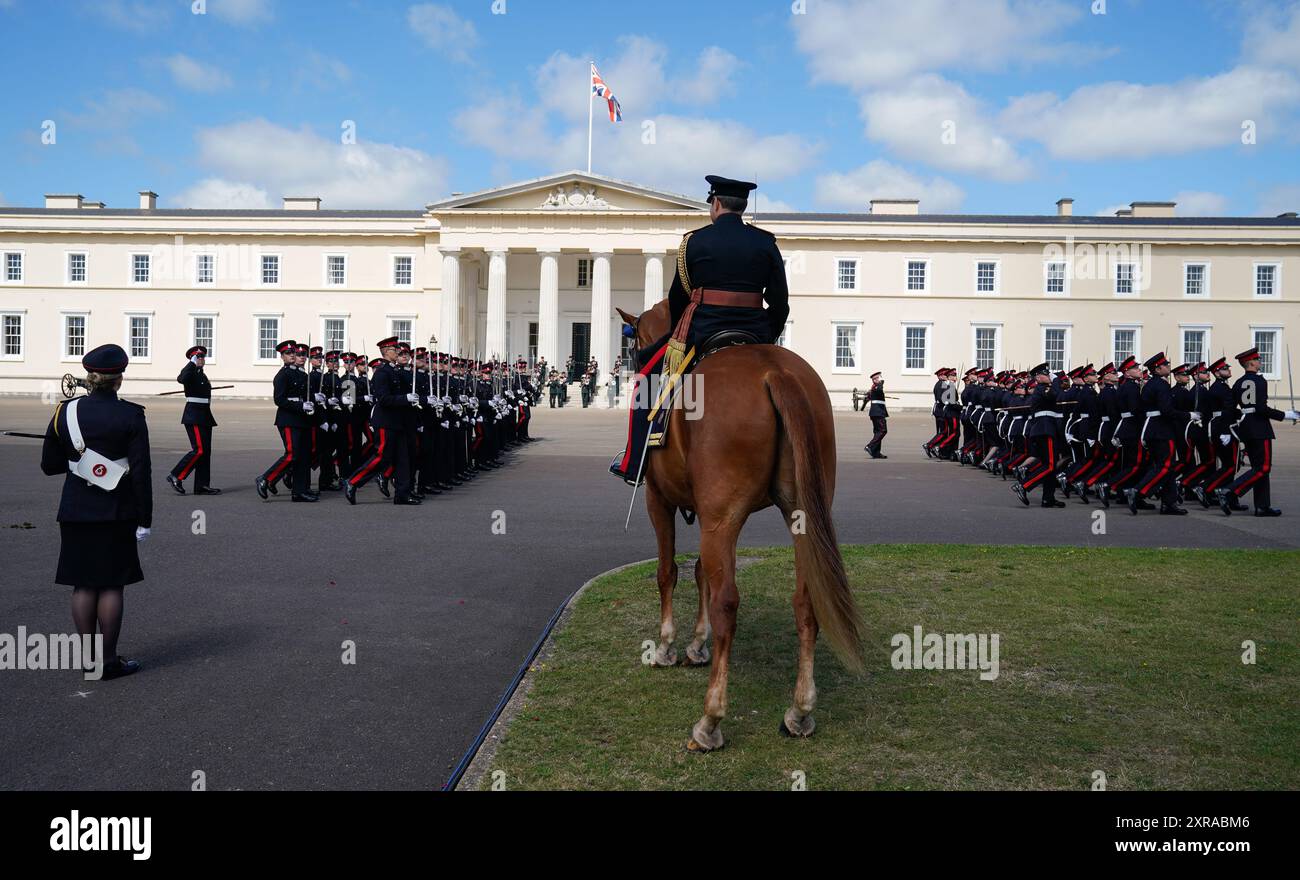 The Academy Adjutant on horse back looks on as Officer Cadets parade ...