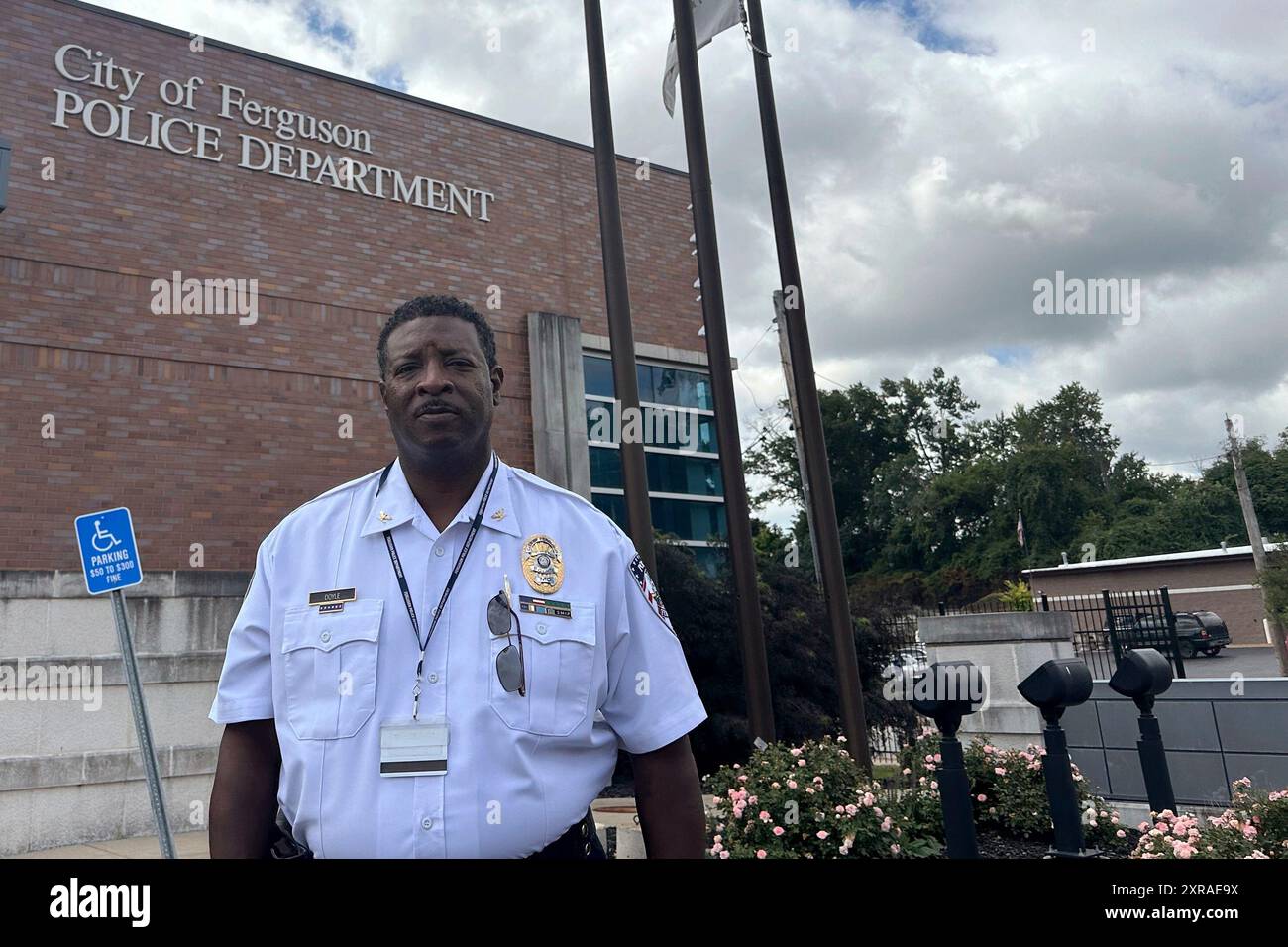 Police Chief Troy Doyle stands in front of the Ferguson Police Station ...