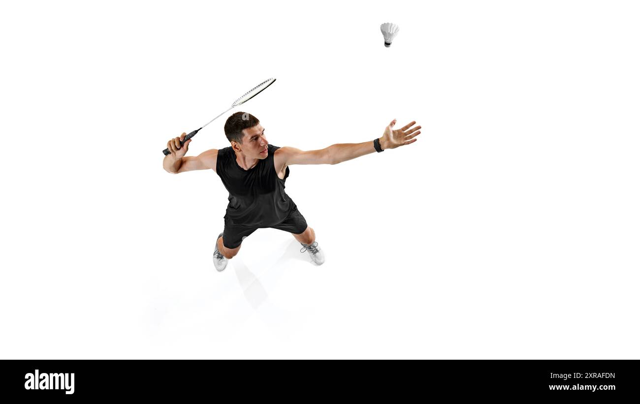 Concentrated young man, badminton player practicing, playing, serving ...