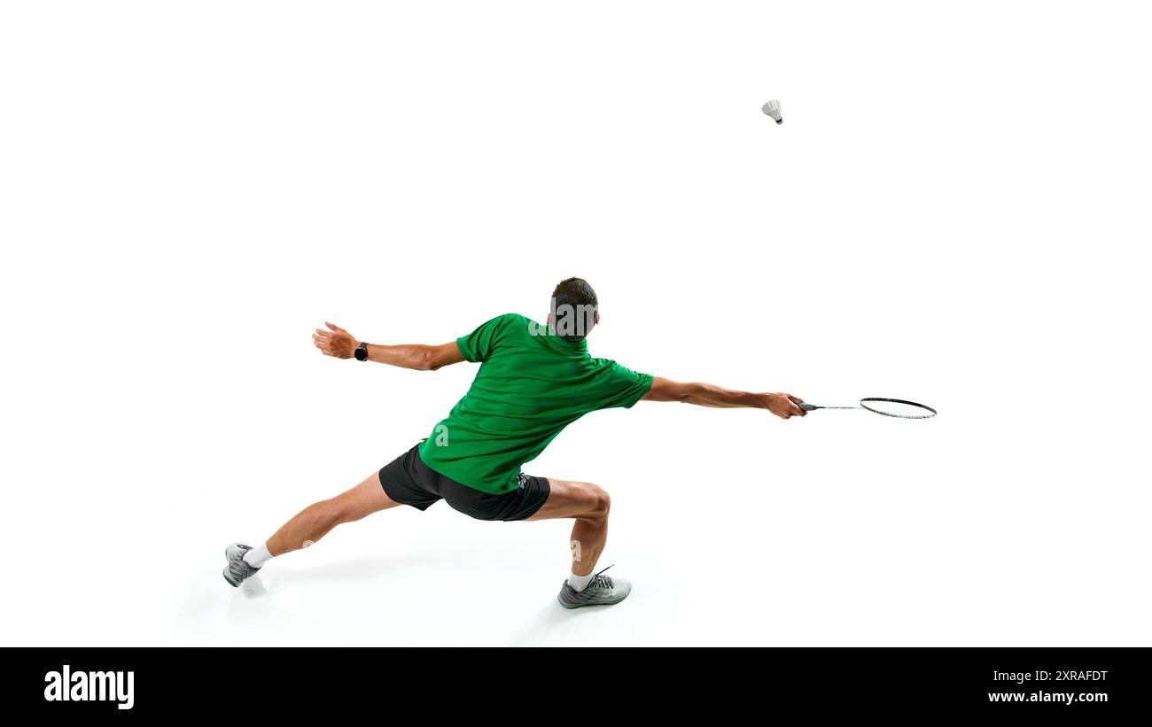 Strength and agility. Young man, badminton athlete in green t-shirt ...