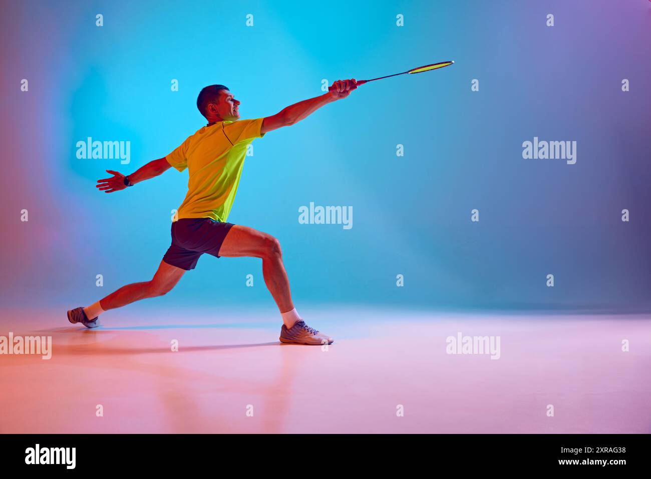 Focused and motivated man, badminton player training, playing with ...