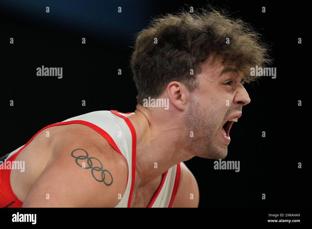Boady Santavy of Canada competes during the men's 89kg weightlifting ...