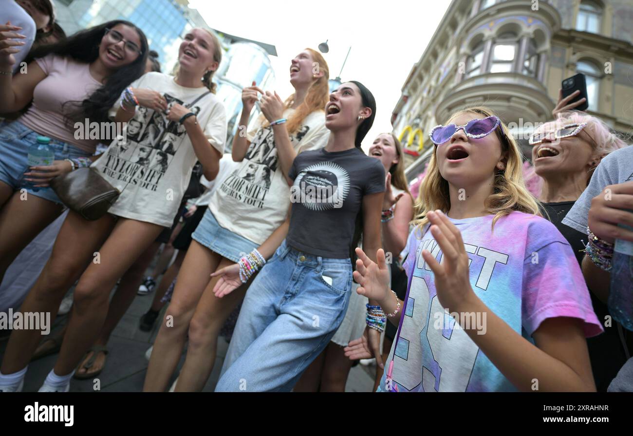 Swifties singing and dancing, pictured in downtown Vienna on August 8 ...