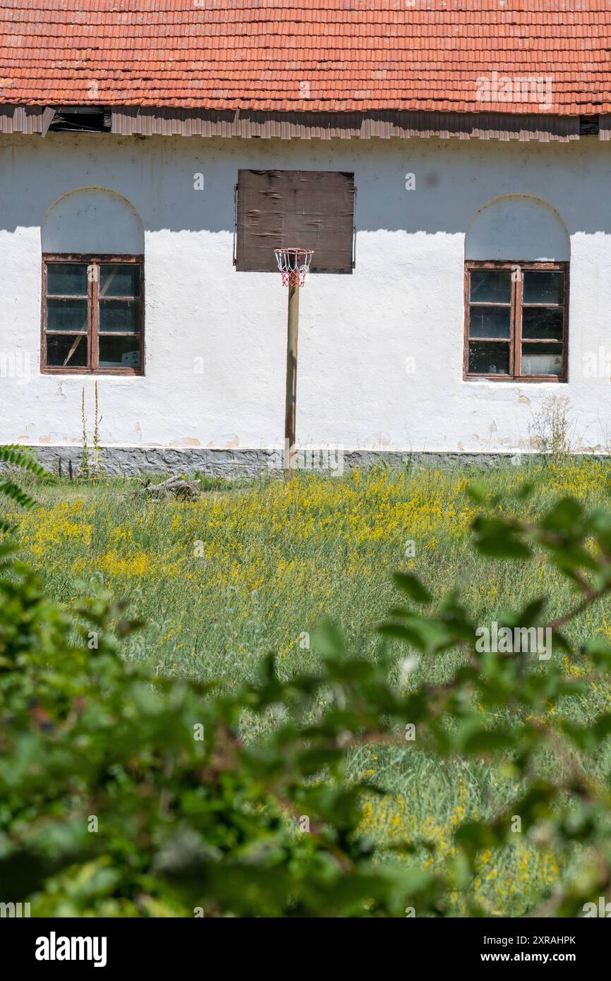 Old Abandoned Building Architecture: School Yard with Basketball Post ...