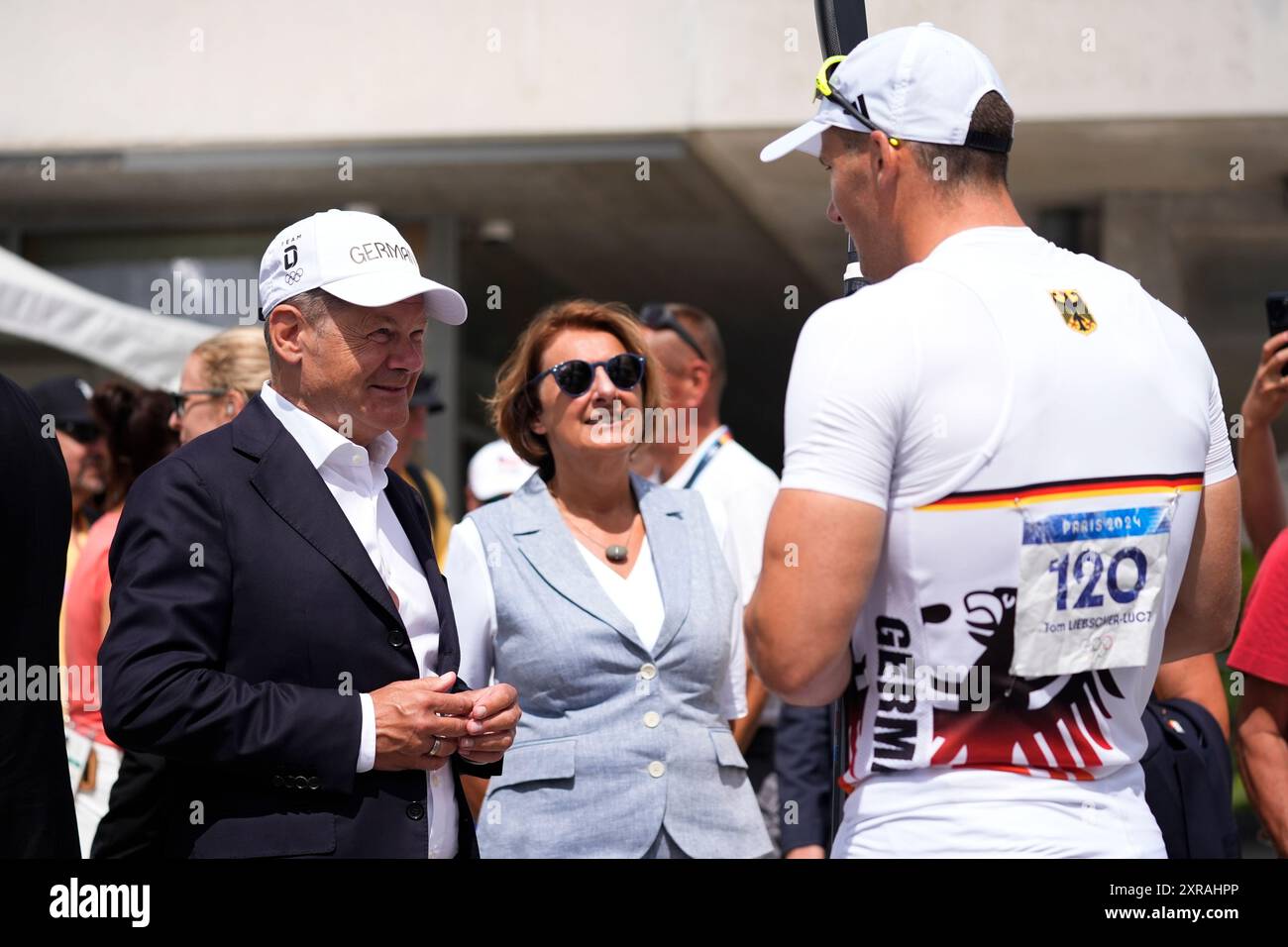 German Chancellor Olaf Scholz and his wife Britta Ernst talks with ...