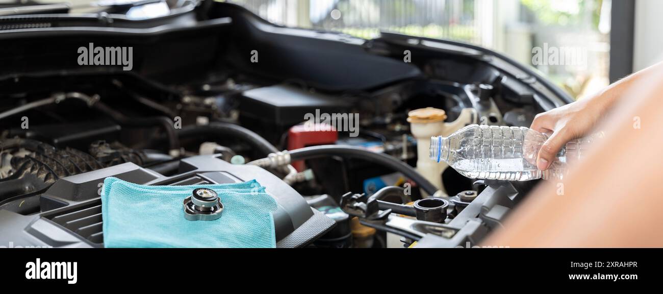 A person is pouring water into a car radiator. The person is trying to ...