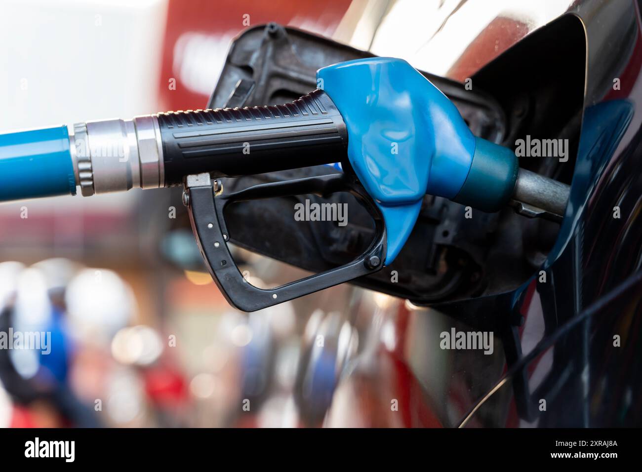 Cropped picture of a fuel nozzle filling a vehicle tank. Car refueling ...