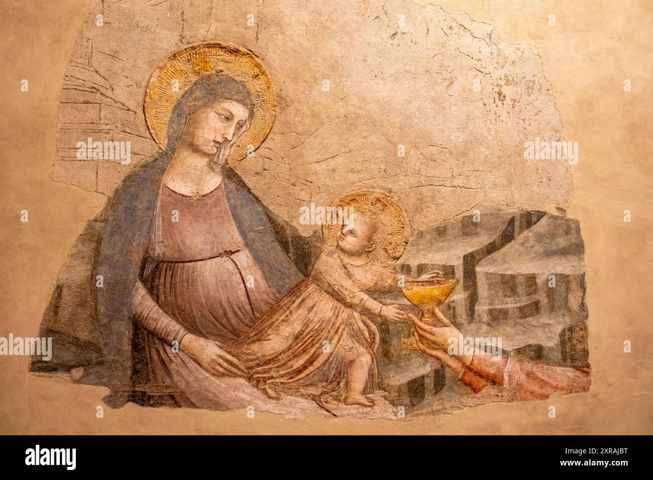 Close-up on medieval wall fresco portraiting Virgin Mary looking at ...