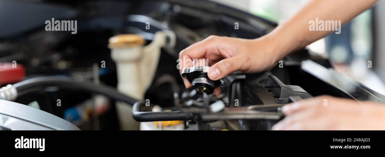 A person is holding a funnel and pouring coolant into the radiator of a ...