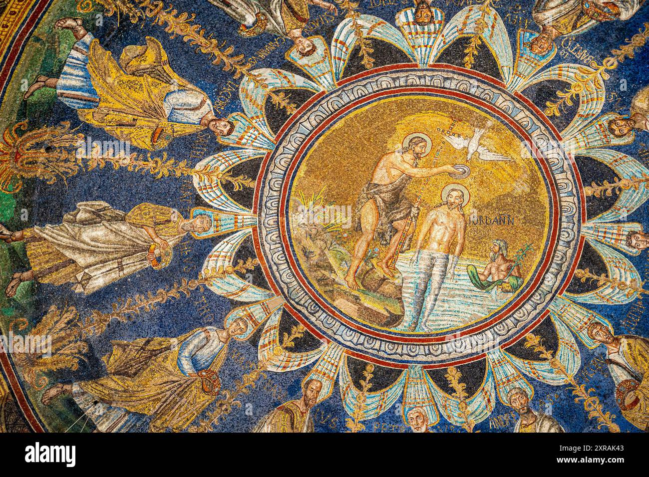 Close-up on religious mosaic decorating the ceiling of catholic Basilica in Ravenna showing a ...