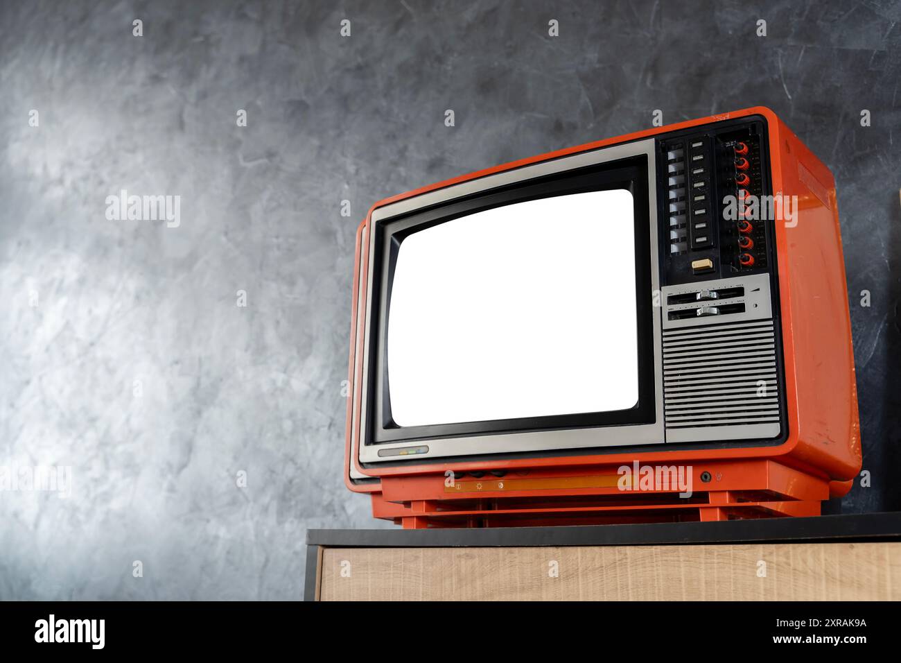 A vintage television set sits on a dresser in a bedroom. A retro ...