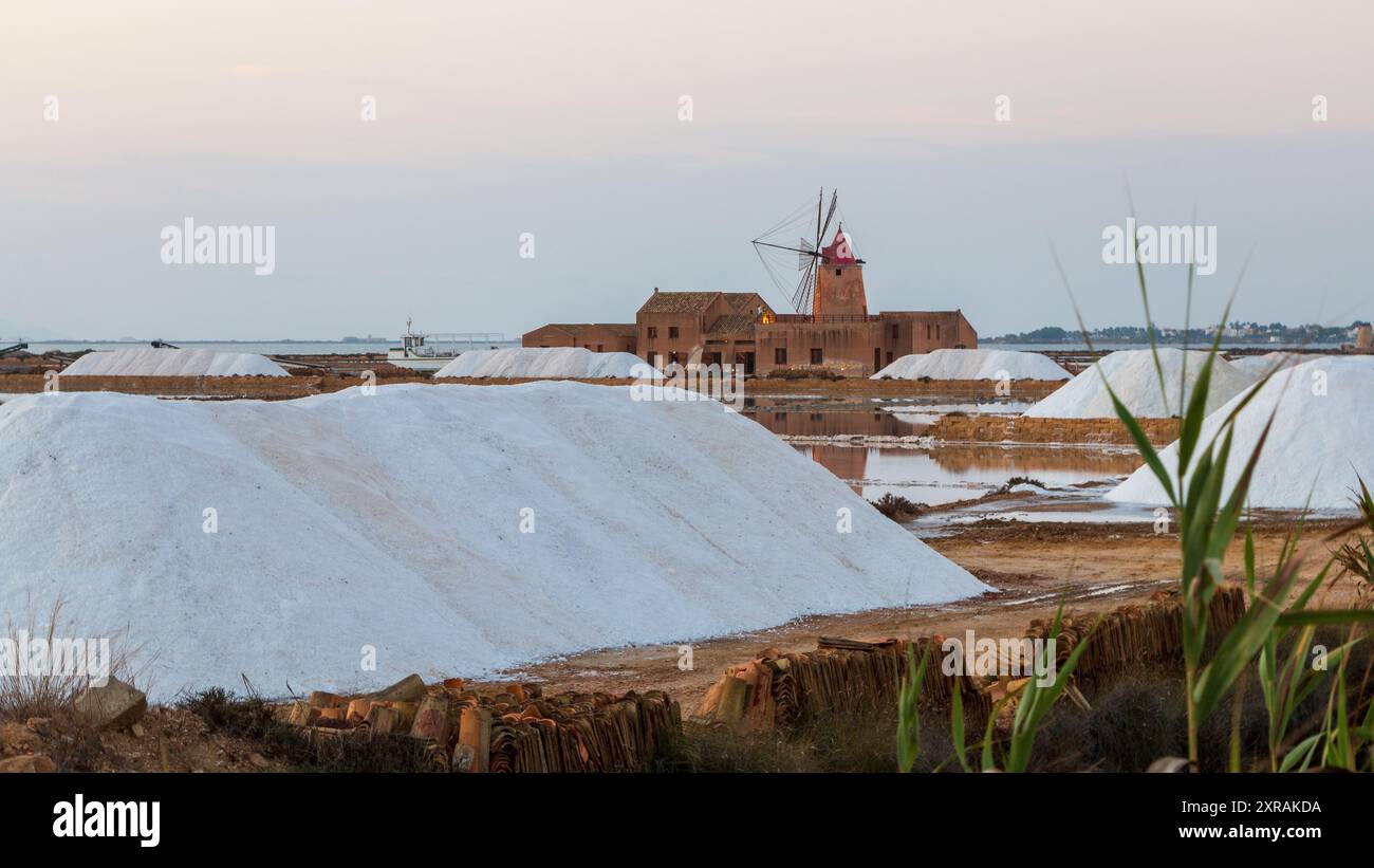 windmill and piles of white salt in the famous salt mines of Marsala ...