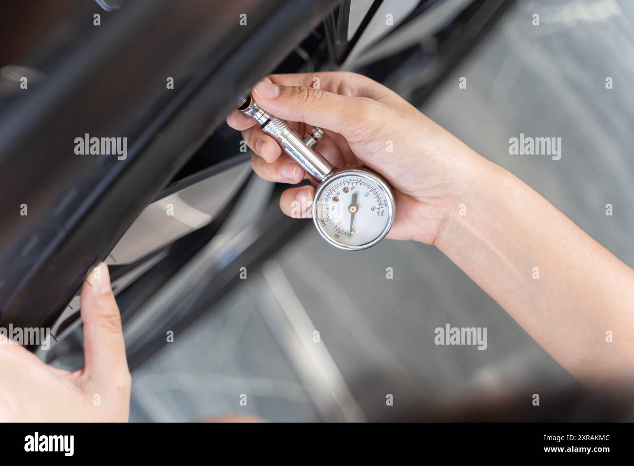 Close-Up Of Hand holding pressure gauge for car tyre pressure ...