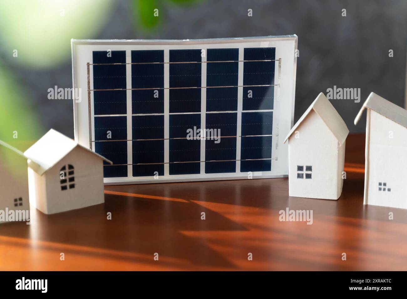 On desk of engineers lay model of house And solar panels to use in ...