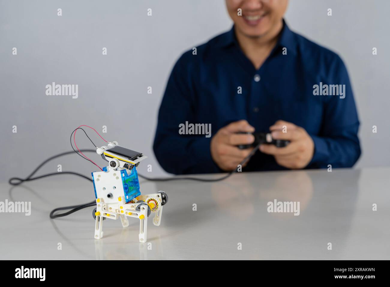 Teacher collects a handmade metal and plastic robot. STEM education for children and teenagers ...