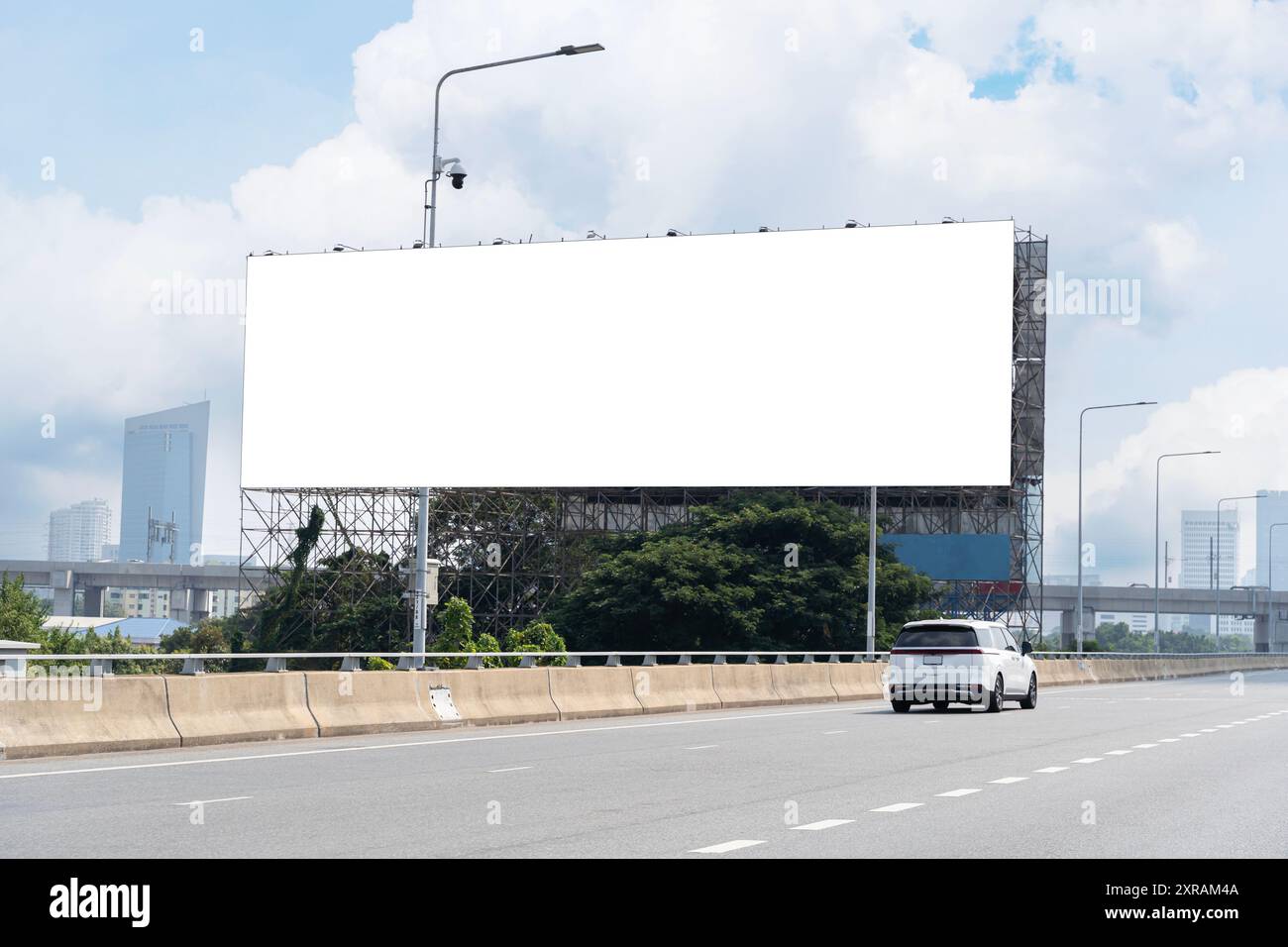 Blank billboard advertising erected outside against a cityscape,copy ...