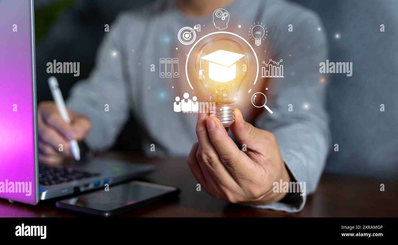 Hand showing graduation hat icon in light bulb. Internet education ...