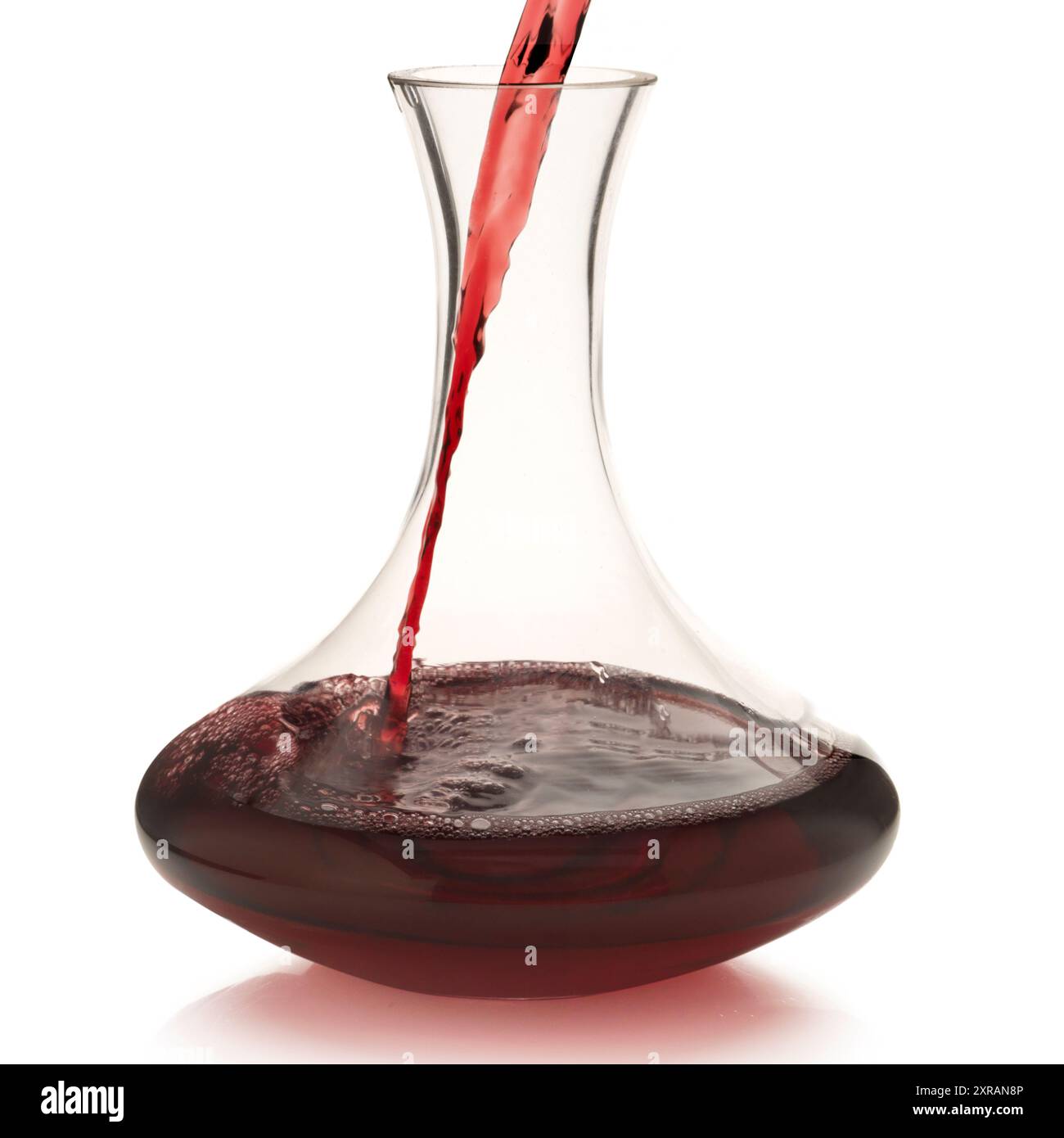 serving wine in transparent glass decanter with white background in ...