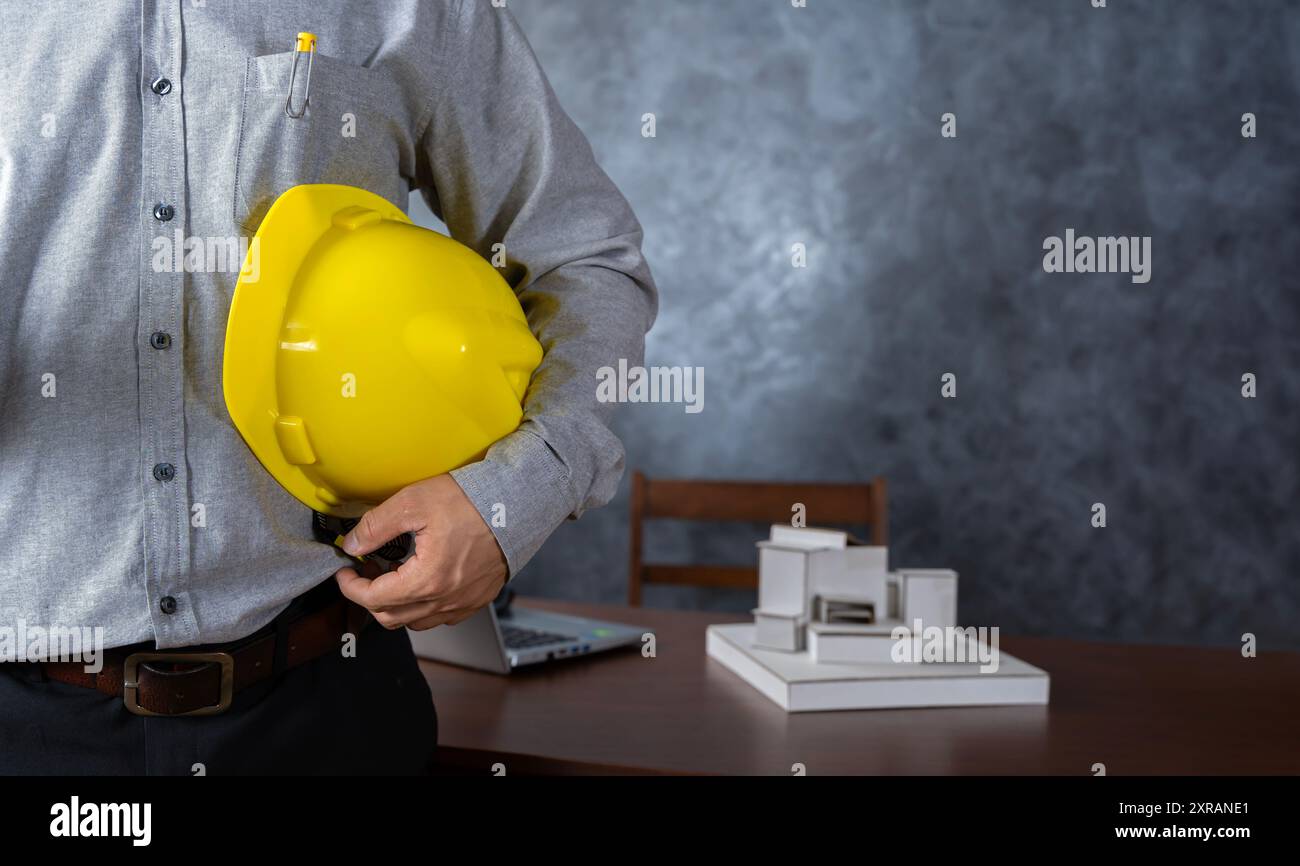 Close-up of Engineer holding helmet checking accuracy of building ...