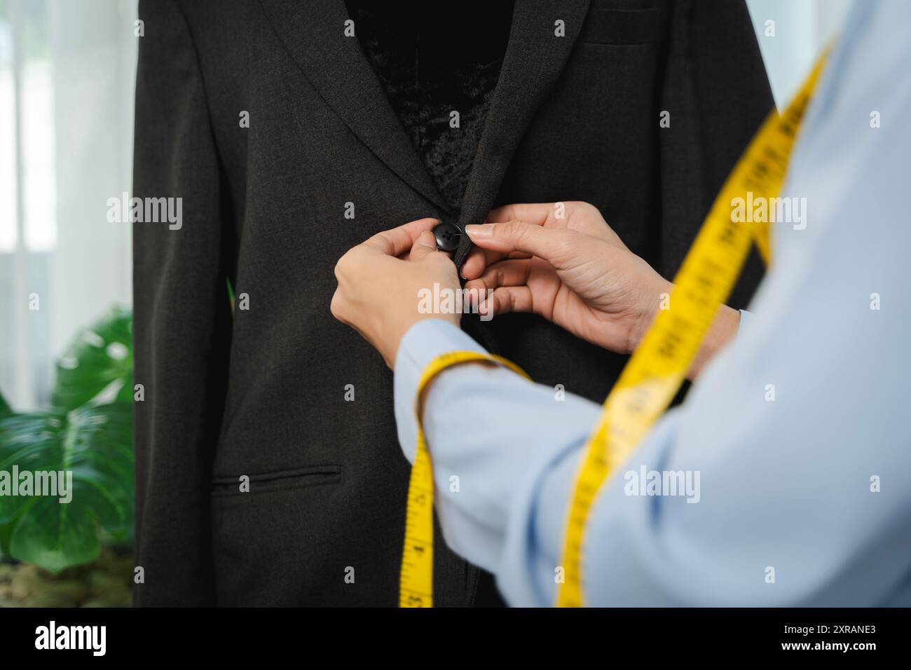 Close-up of tailoring a tailored suit on a male model, hands with ...