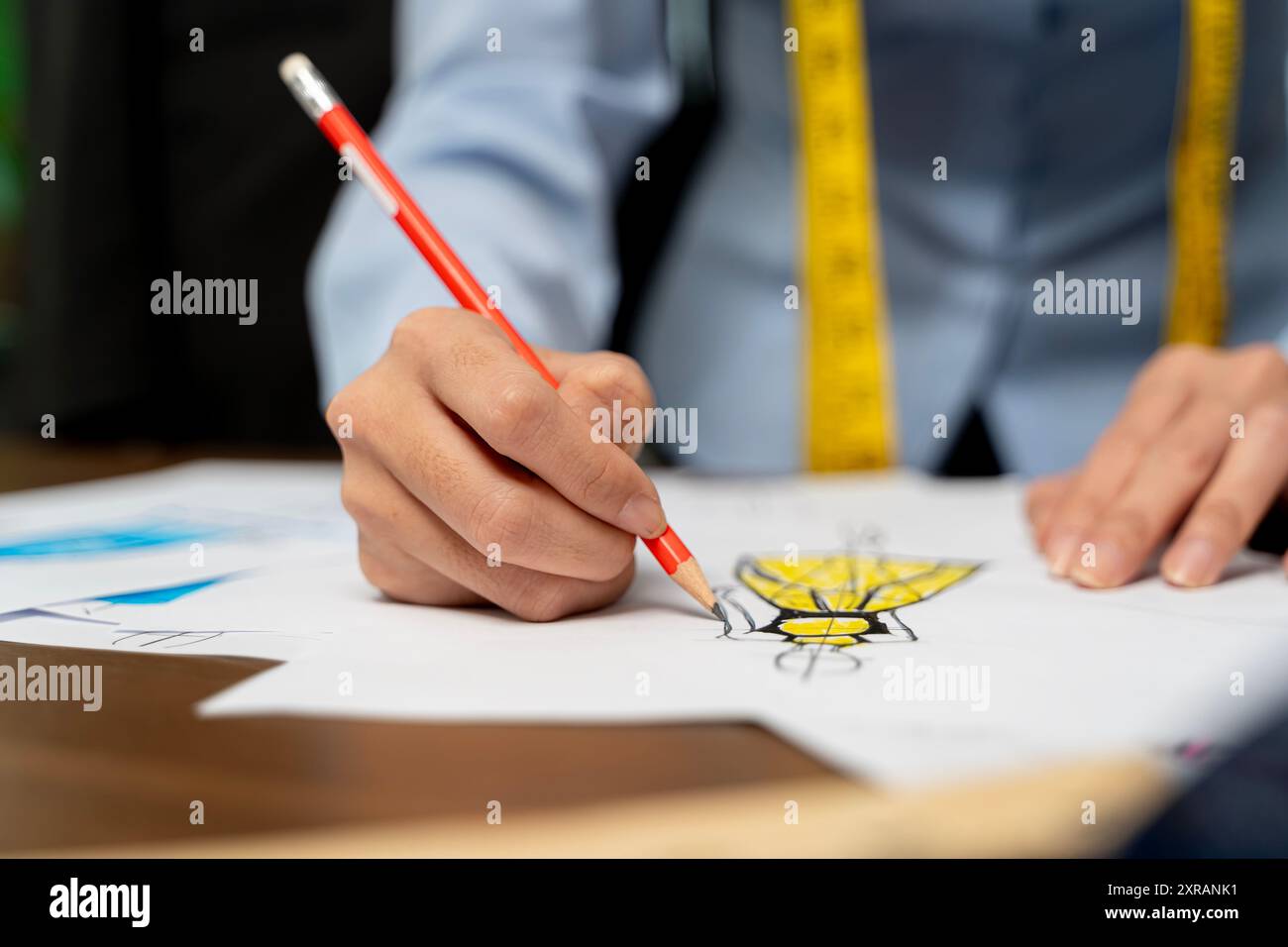 Female dressmaker or hands of fashion designer drawing sketches model ...