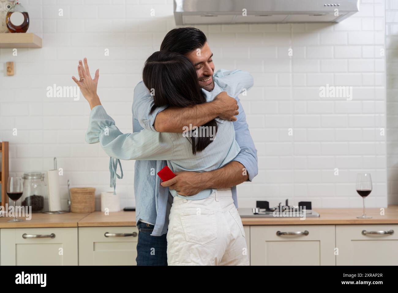 Attractive young man proposes marriage to beautiful happy woman ...