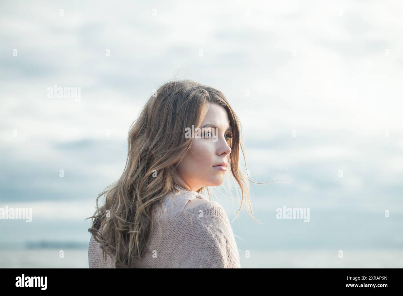 Fashion portrait of young adult female model with windy brown hair ...