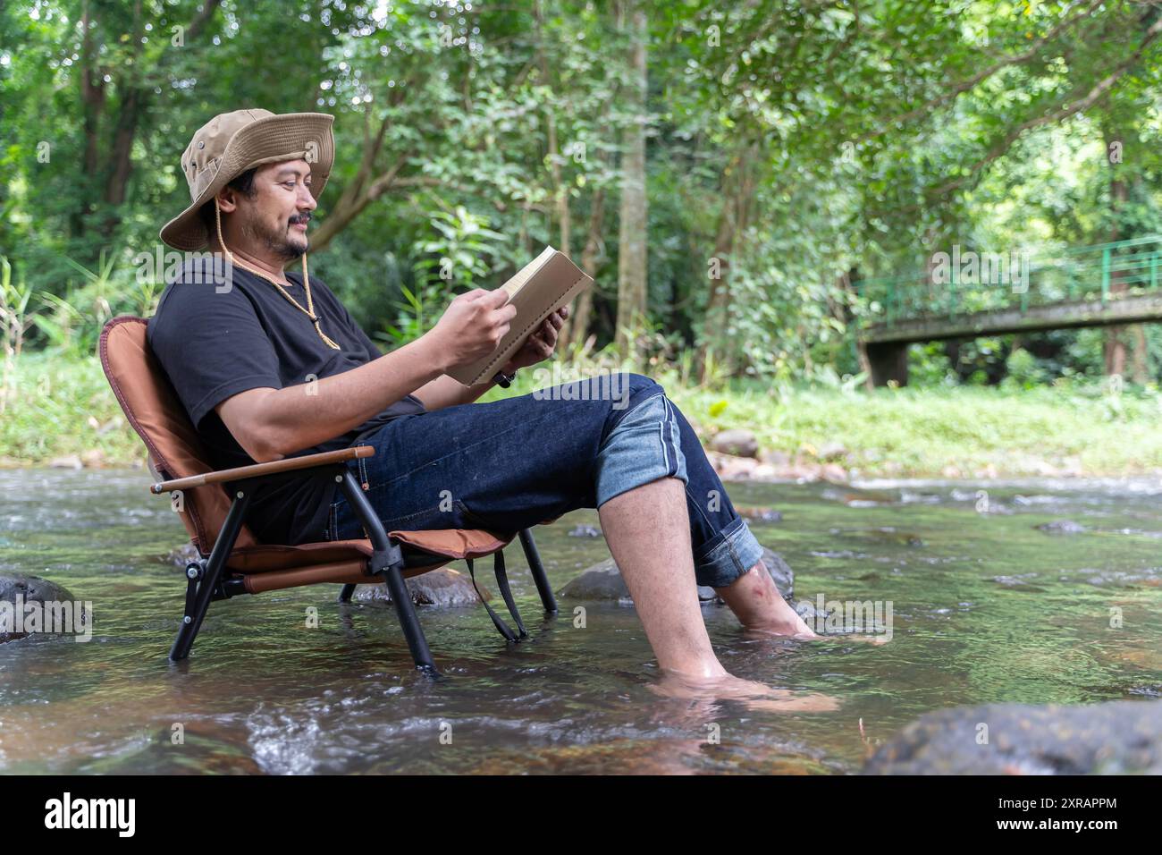 Young man sits outside hi-res stock photography and images - Alamy